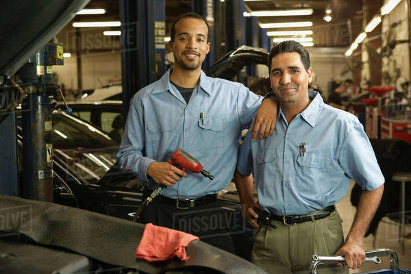Multi-ethnic male auto mechanics in shop - Royalty-free Stock Photo ...