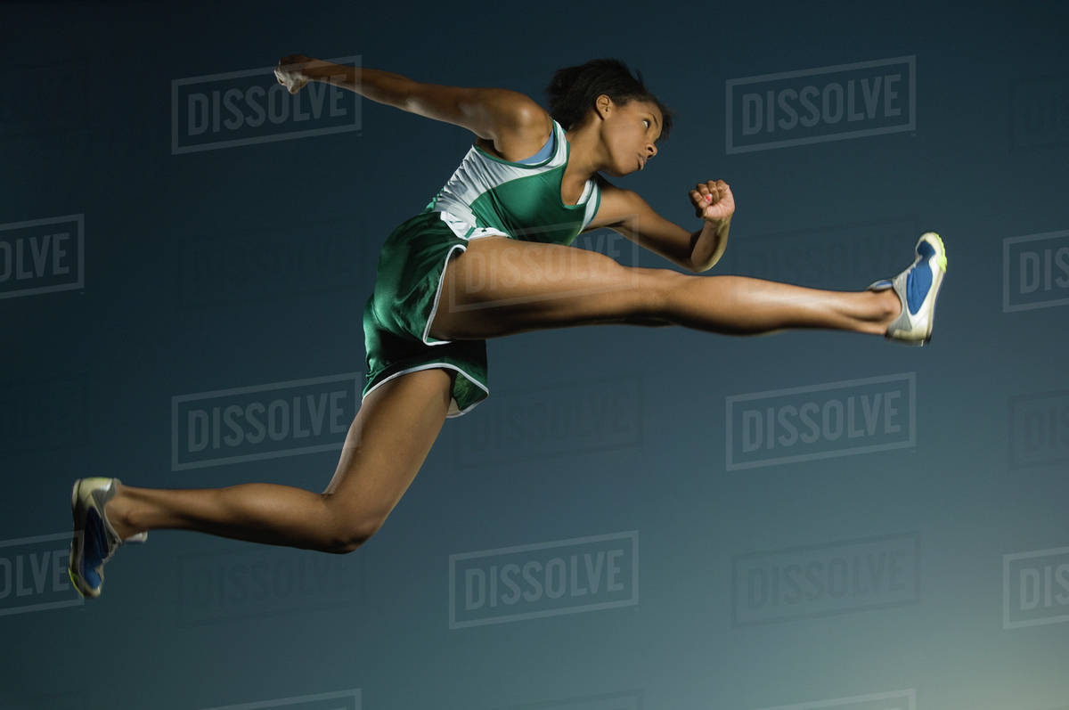 African American female athlete jumping - Royalty-free Stock Photo ...