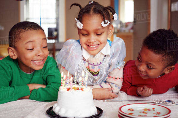 Smiling children admiring cake at party - Royalty-free Stock Photo ...