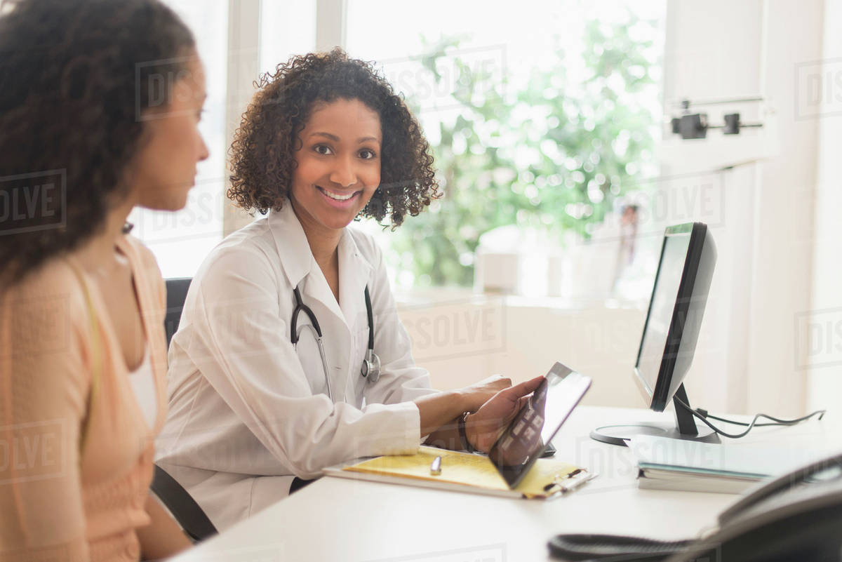 Doctor and patient using digital tablet in office - Royalty-free Stock ...