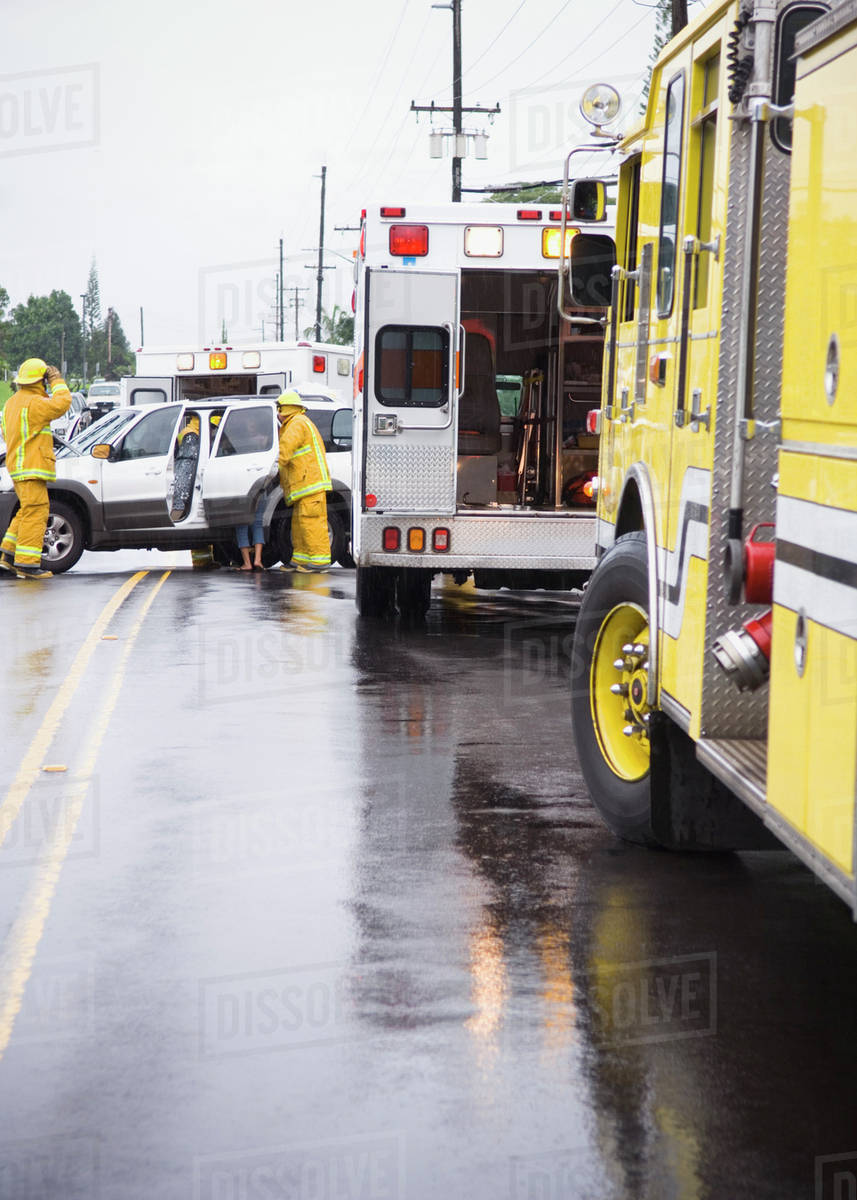 Firefighters at accident scene - Royalty-free Stock Photo | Dissolve