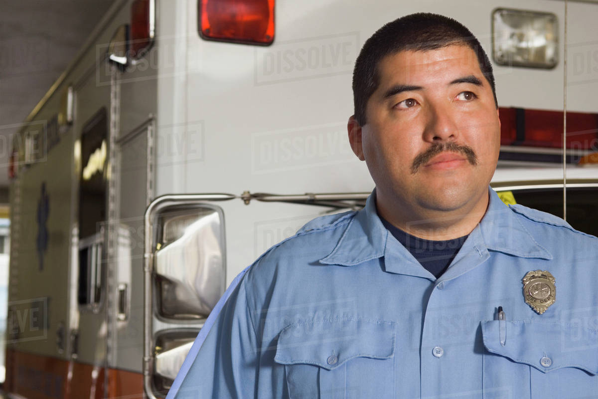 Asian male paramedic in front of ambulance - Stock Photo - Dissolve