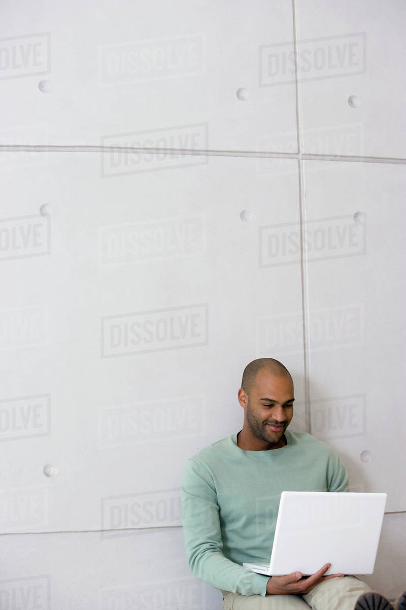 African man looking at laptop - Royalty-free Stock Photo | Dissolve