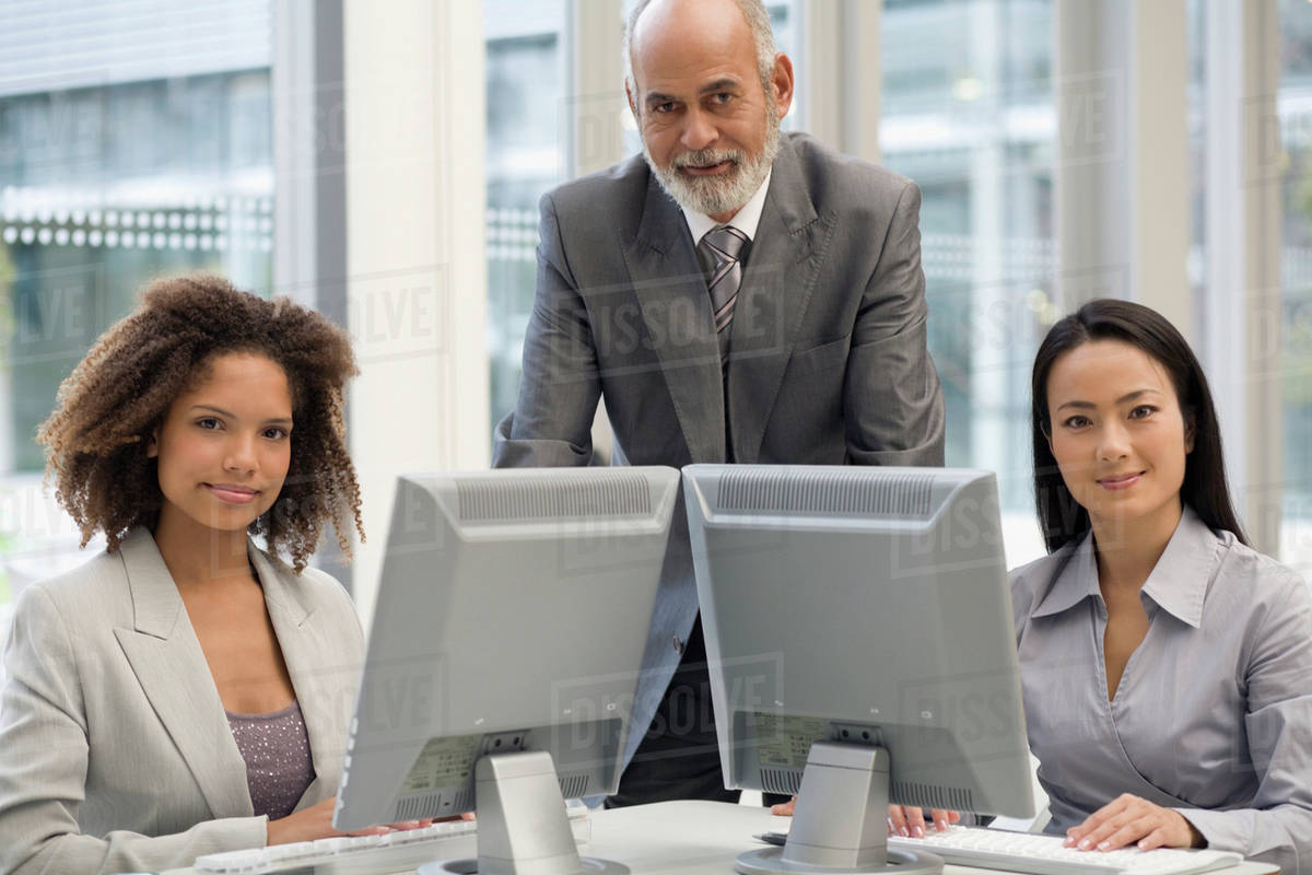 Multi-ethnic businesspeople behind computers - Royalty-free Stock Photo ...