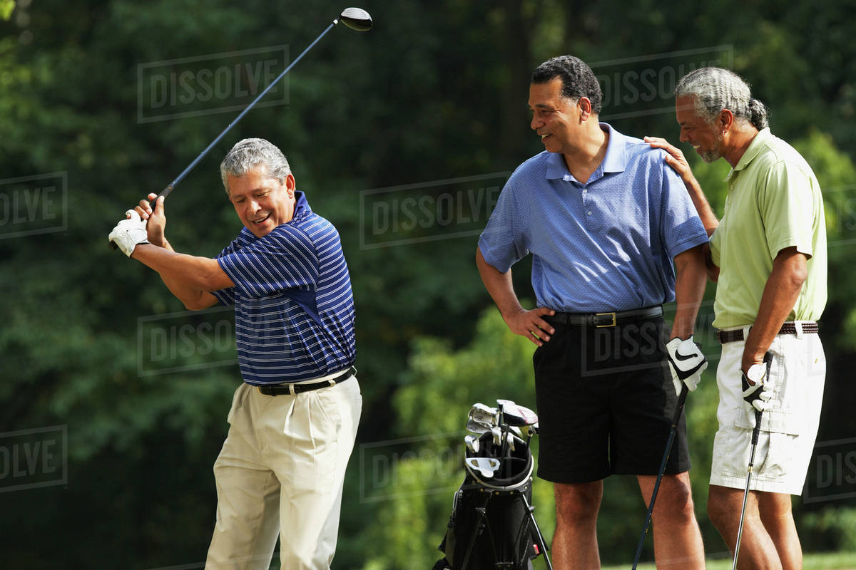 Multi-ethnic men playing golf - Royalty-free Stock Photo | Dissolve