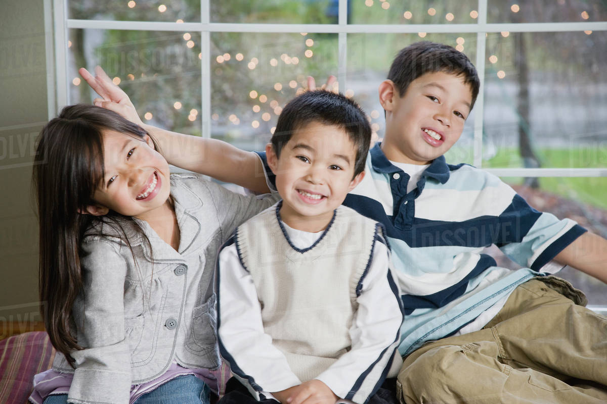 Mixed Race siblings acting silly - Royalty-free Stock Photo | Dissolve