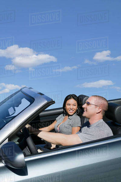 Multi-ethnic couple driving in convertible car - Royalty-free Stock ...