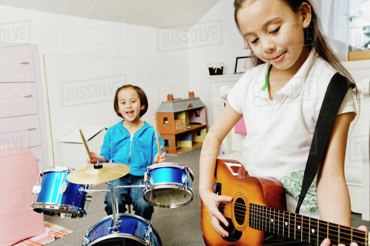 Asian sisters playing drums and guitar - Royalty-free Stock Photo ...
