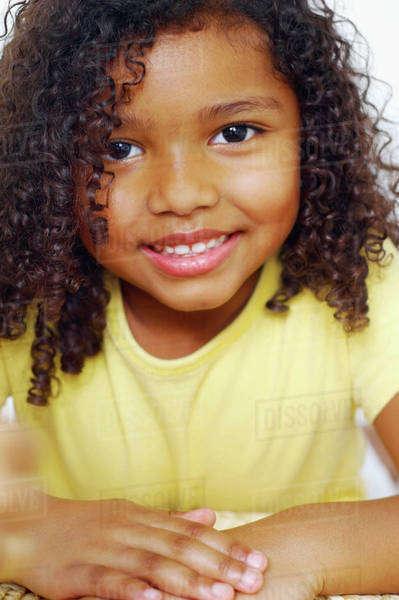 Close up of mixed race girl smiling - Stock Photo - Dissolve