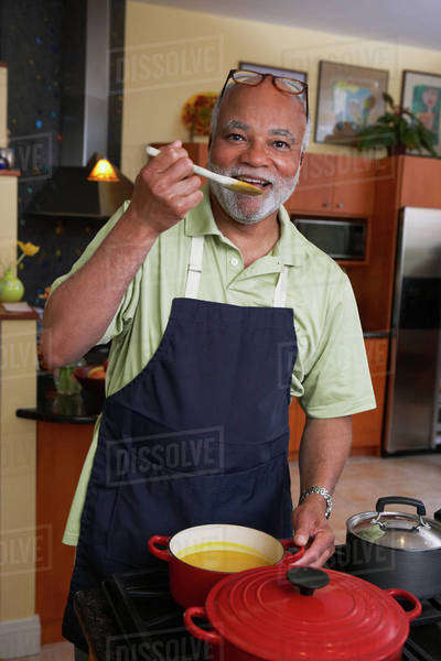 African man cooking dinner - Royalty-free Stock Photo | Dissolve