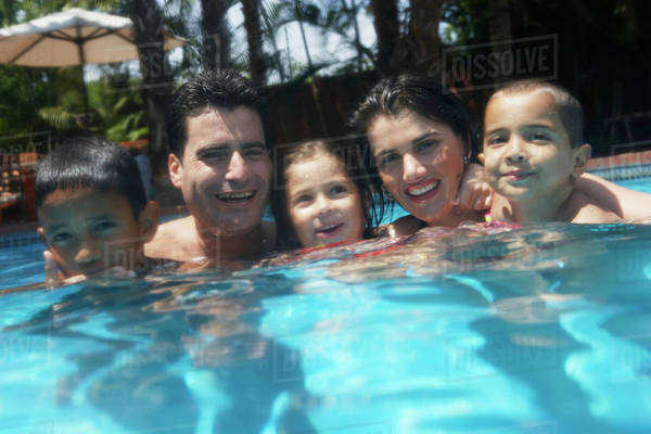 Family swimming in swimming pool - Royalty-free Stock Photo | Dissolve
