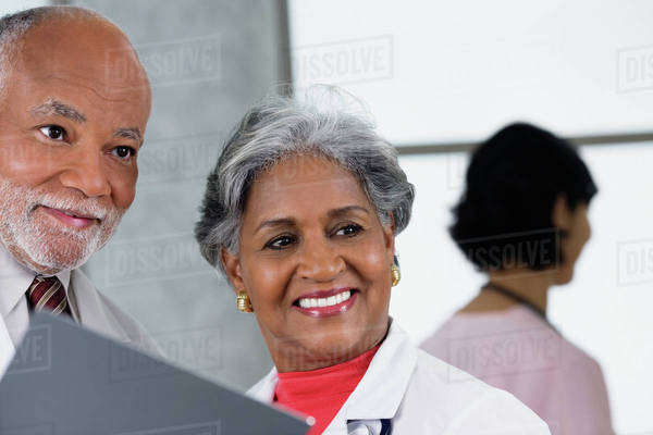 Two African doctors talking together - Stock Photo - Dissolve