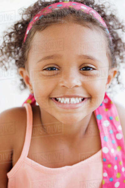 Close up of mixed race girl smiling - Royalty-free Stock Photo | Dissolve