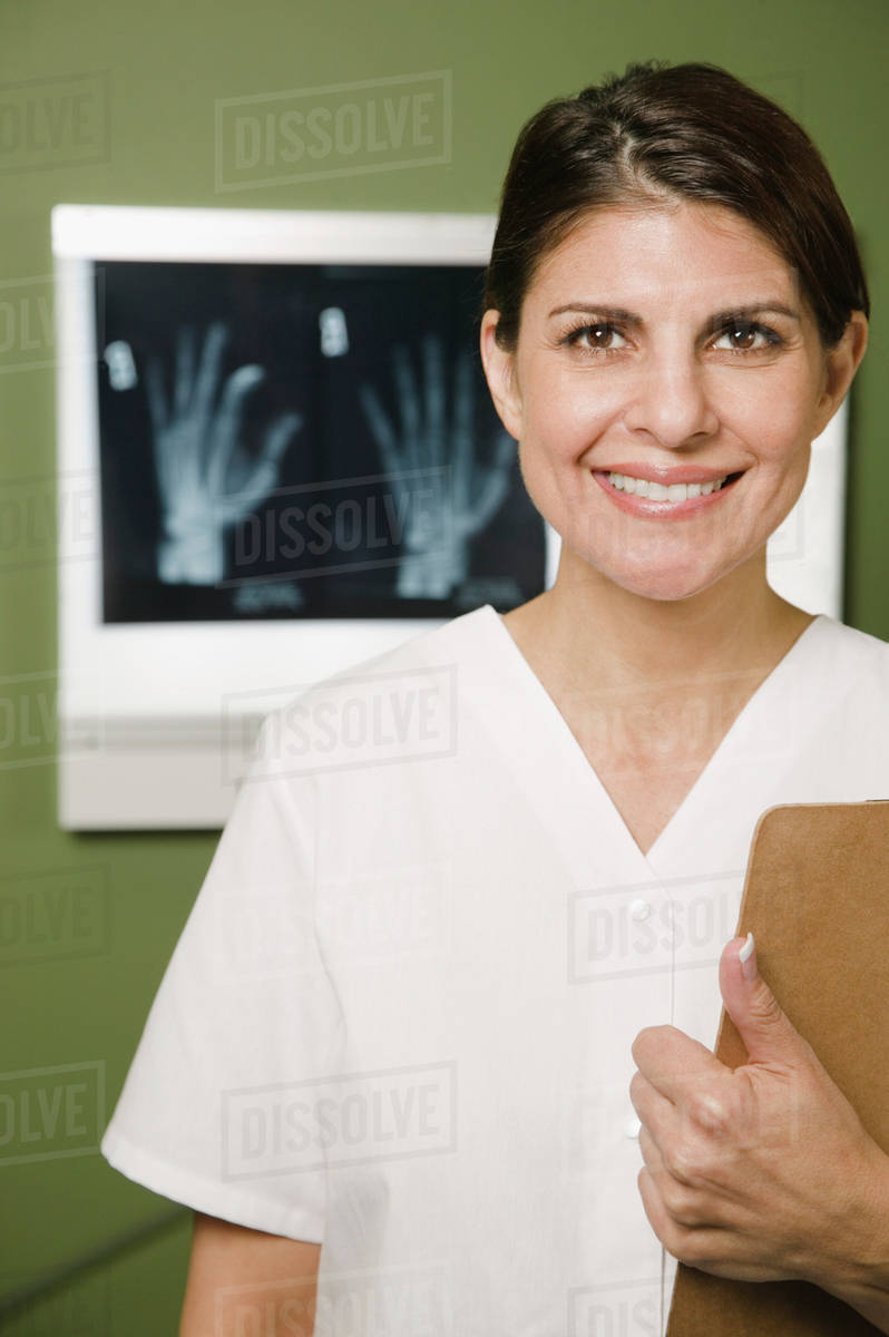 Doctor with medical chart and x-rays - Royalty-free Stock Photo | Dissolve