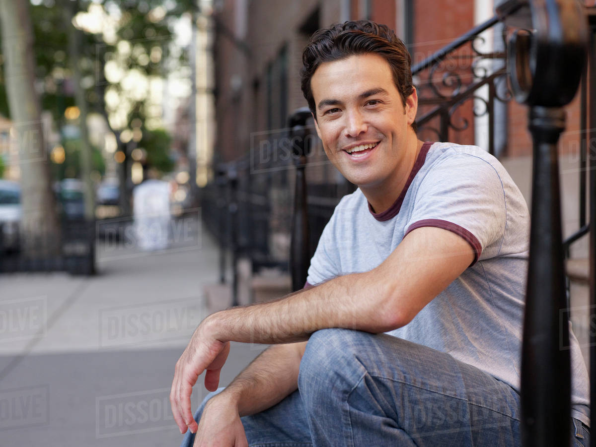 Man sitting on front stoop - Royalty-free Stock Photo | Dissolve