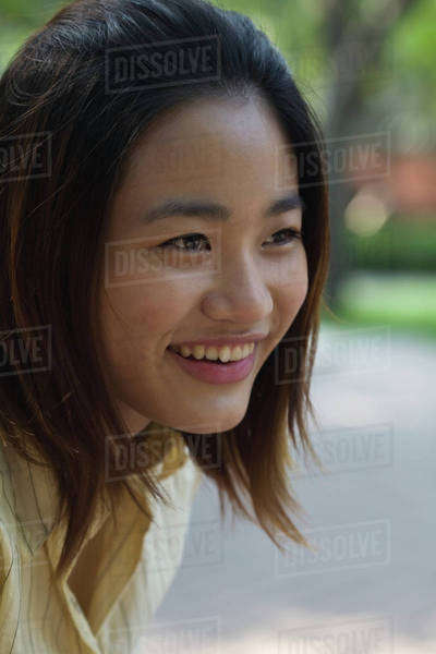 Confident Chinese woman smiling - Stock Photo - Dissolve
