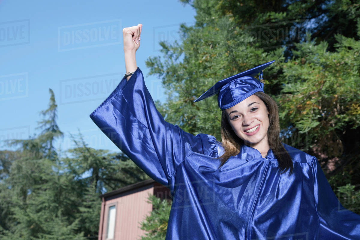 Mixed race girl celebrating graduation - Stock Photo - Dissolve
