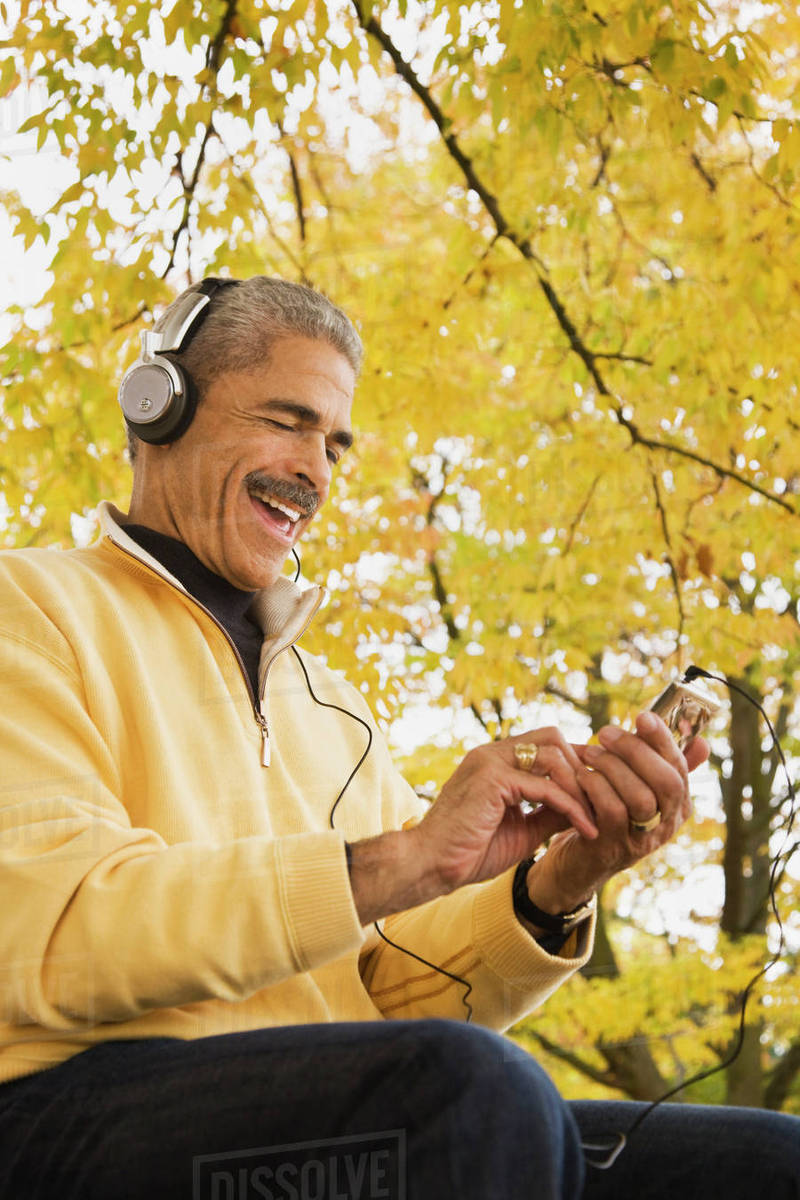 African man listening to mp3 player - Royalty-free Stock Photo | Dissolve
