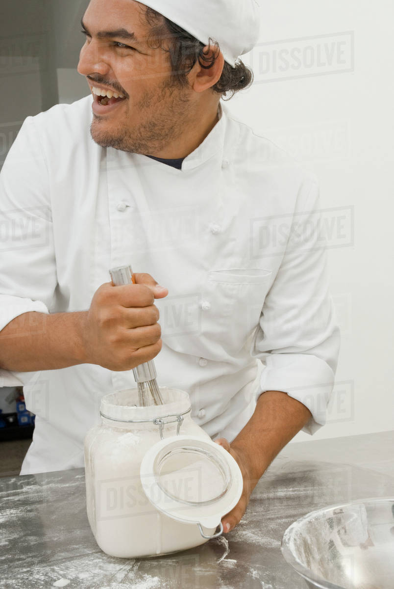 Baker working in bakery kitchen - Royalty-free Stock Photo | Dissolve