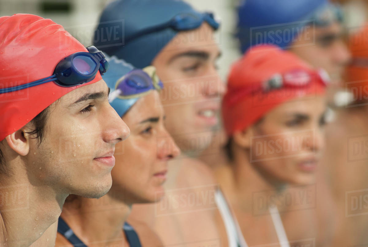 Hispanic swimmers standing in a row - Royalty-free Stock Photo | Dissolve