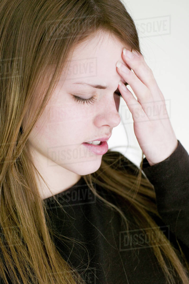 Young woman touching forehead with eyes closed - Royalty-free Stock ...