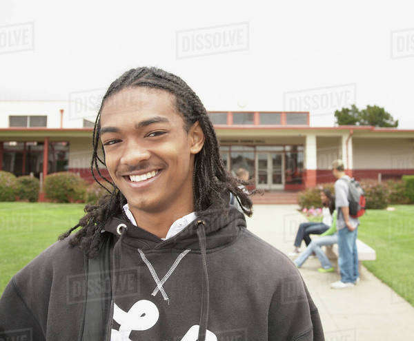 Young African man smiling on school campus - Royalty-free Stock Photo ...