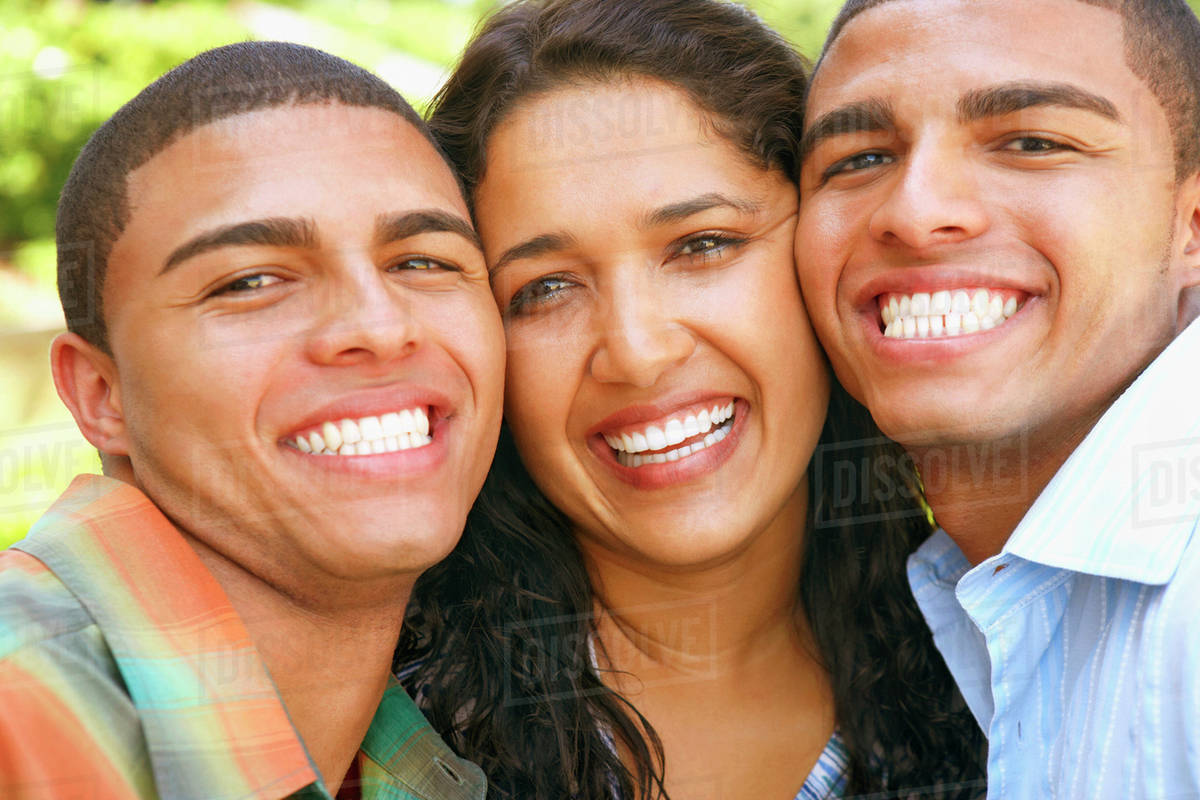 Hispanic siblings hugging - Royalty-free Stock Photo | Dissolve