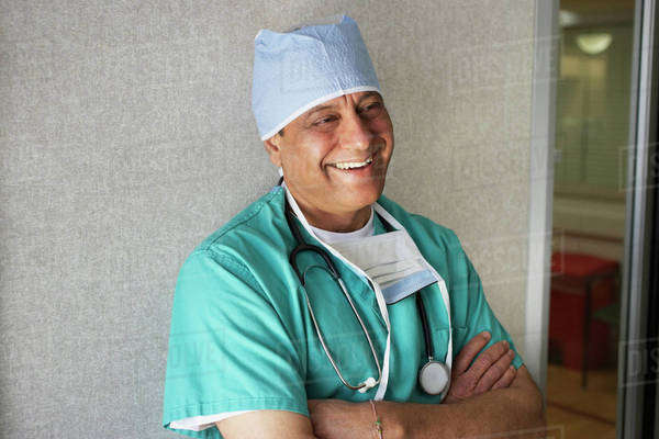 Middle-aged Indian male surgeon laughing - Stock Photo - Dissolve