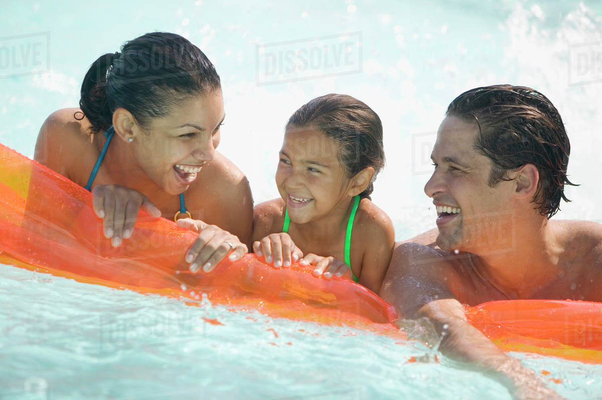 Family in swimming pool - Royalty-free Stock Photo | Dissolve