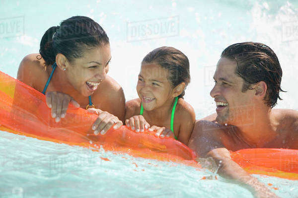 Family in swimming pool - Royalty-free Stock Photo | Dissolve