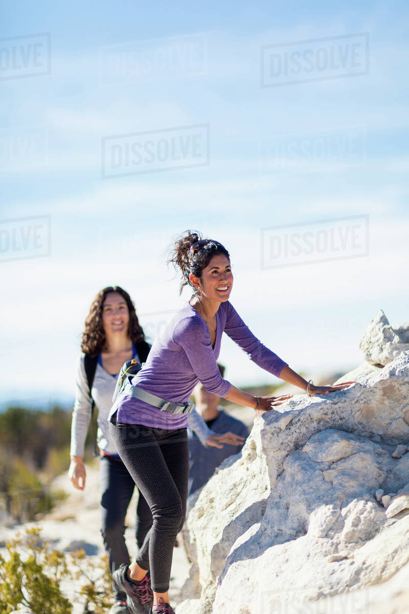 Hikers climbing rocky hillside - Stock Photo - Dissolve