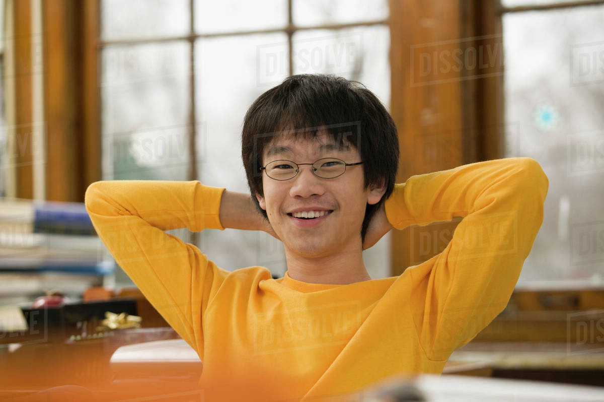 Asian student relaxing in classroom - Royalty-free Stock Photo | Dissolve