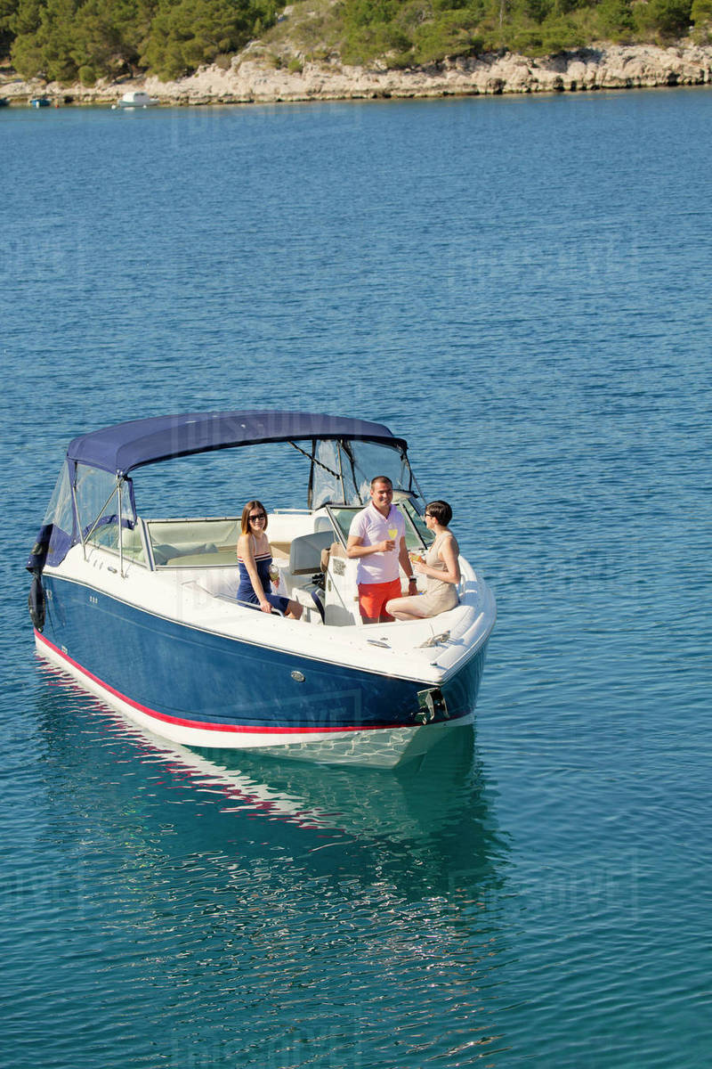 Friends relaxing on boat in ocean - Stock Photo - Dissolve