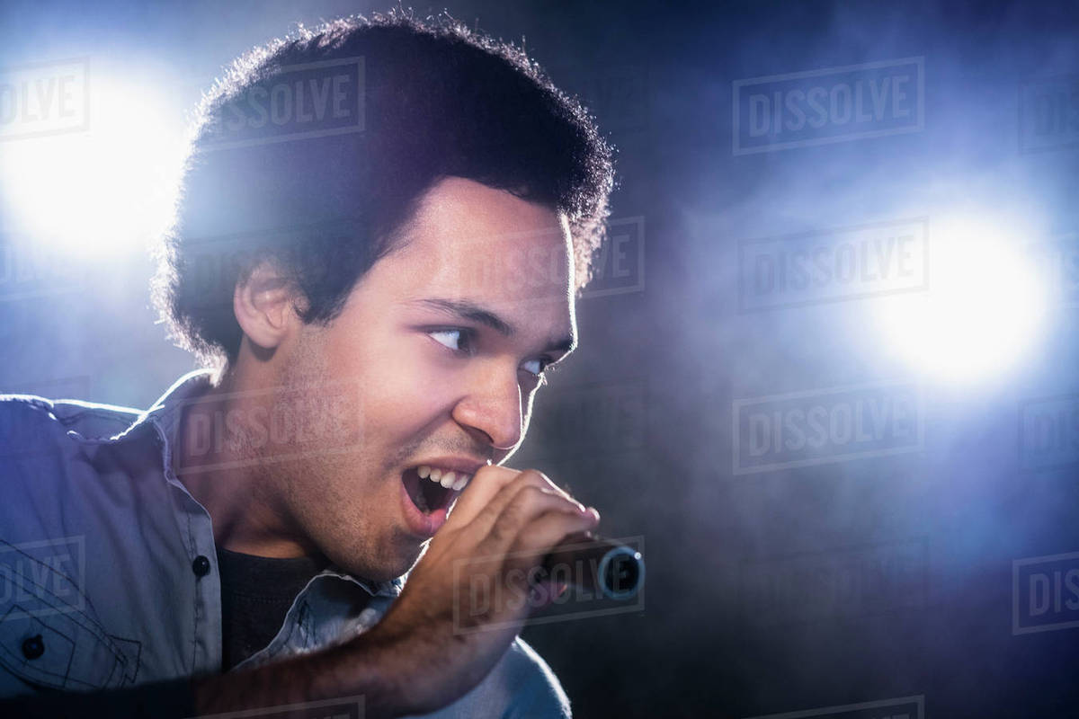 Mixed race singer performing on stage - Stock Photo - Dissolve