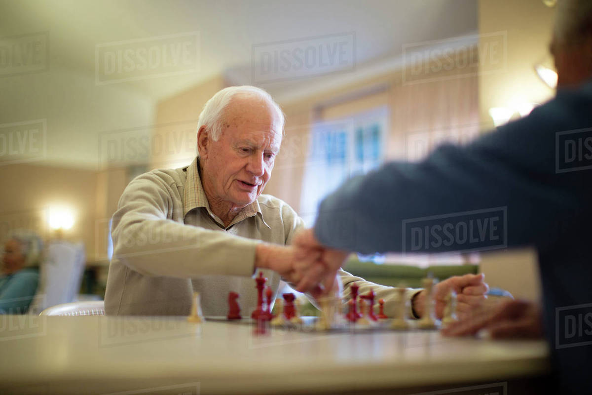 Older men playing chess - Stock Photo - Dissolve