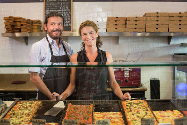 Caucasian servers smiling in cafe - Royalty-free Stock Photo | Dissolve