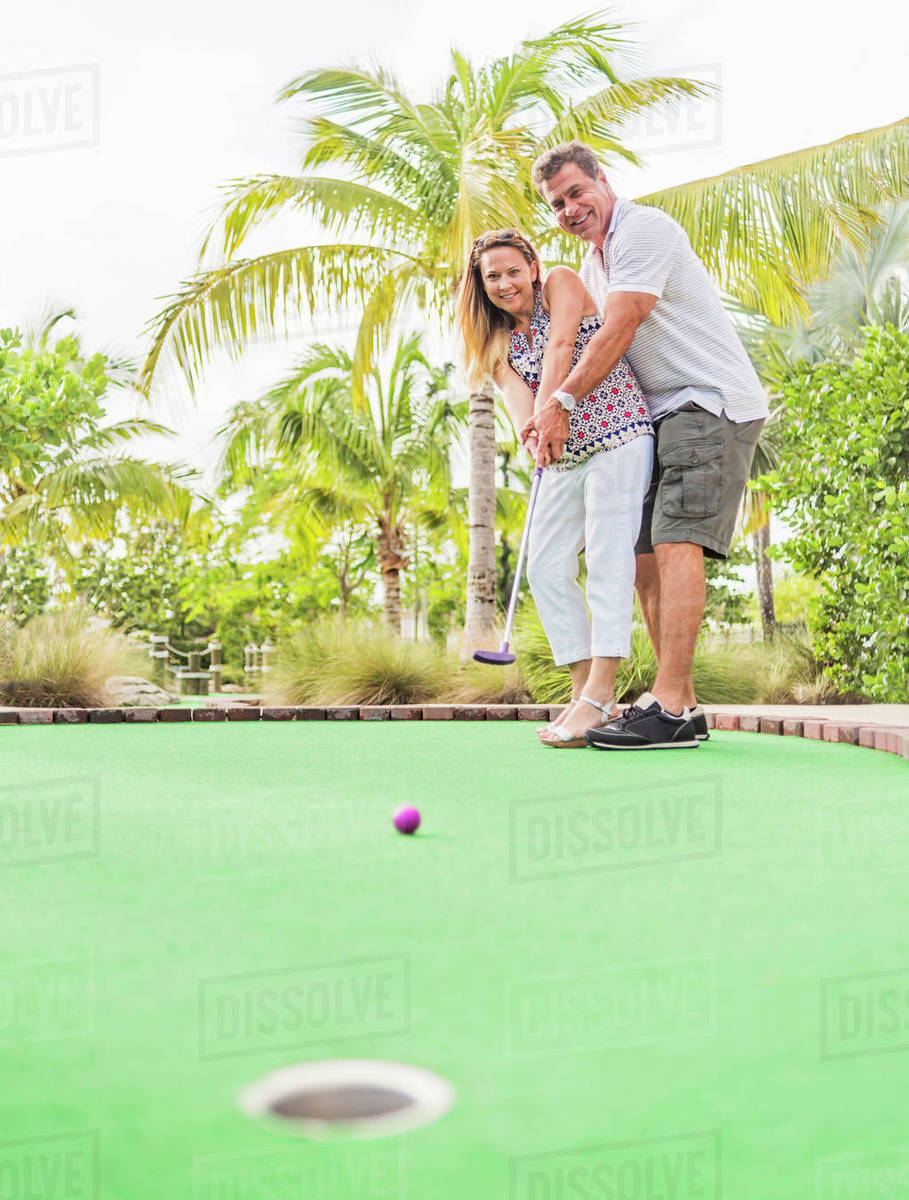 Caucasian couple playing miniature golf - Royalty-free Stock Photo ...