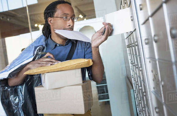 Black man gathering mail from post office box - Royalty-free Stock ...