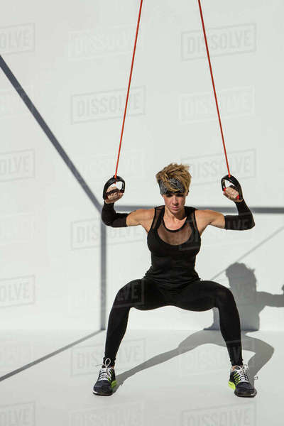 Caucasian athlete exercising with resistance cables - Stock Photo ...