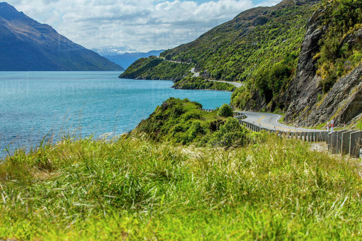 Highway on remote mountains near lake, Queenstown, Otago, New Zealand ...