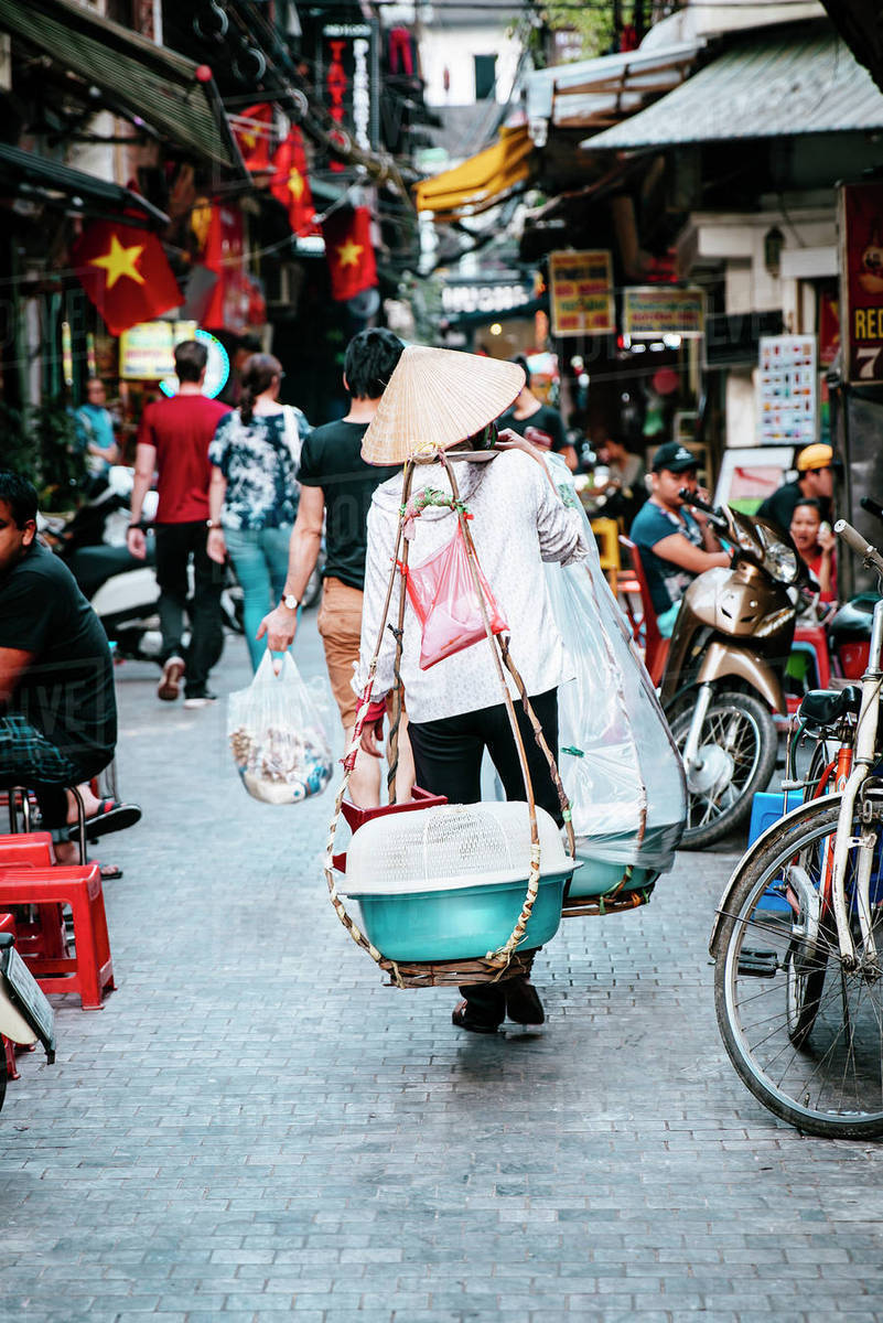 Vendor walking on urban street - Royalty-free Stock Photo | Dissolve