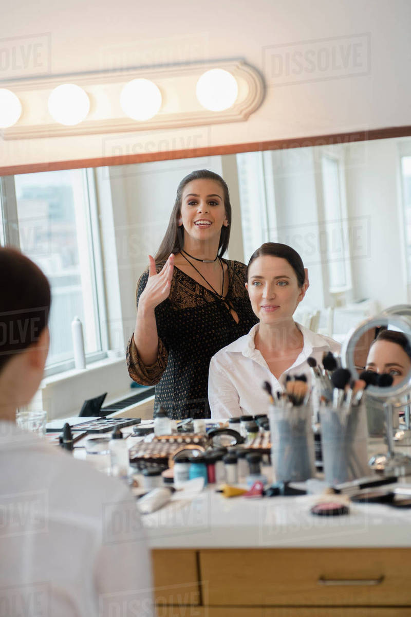 Woman having makeup applied by stylist - Stock Photo - Dissolve
