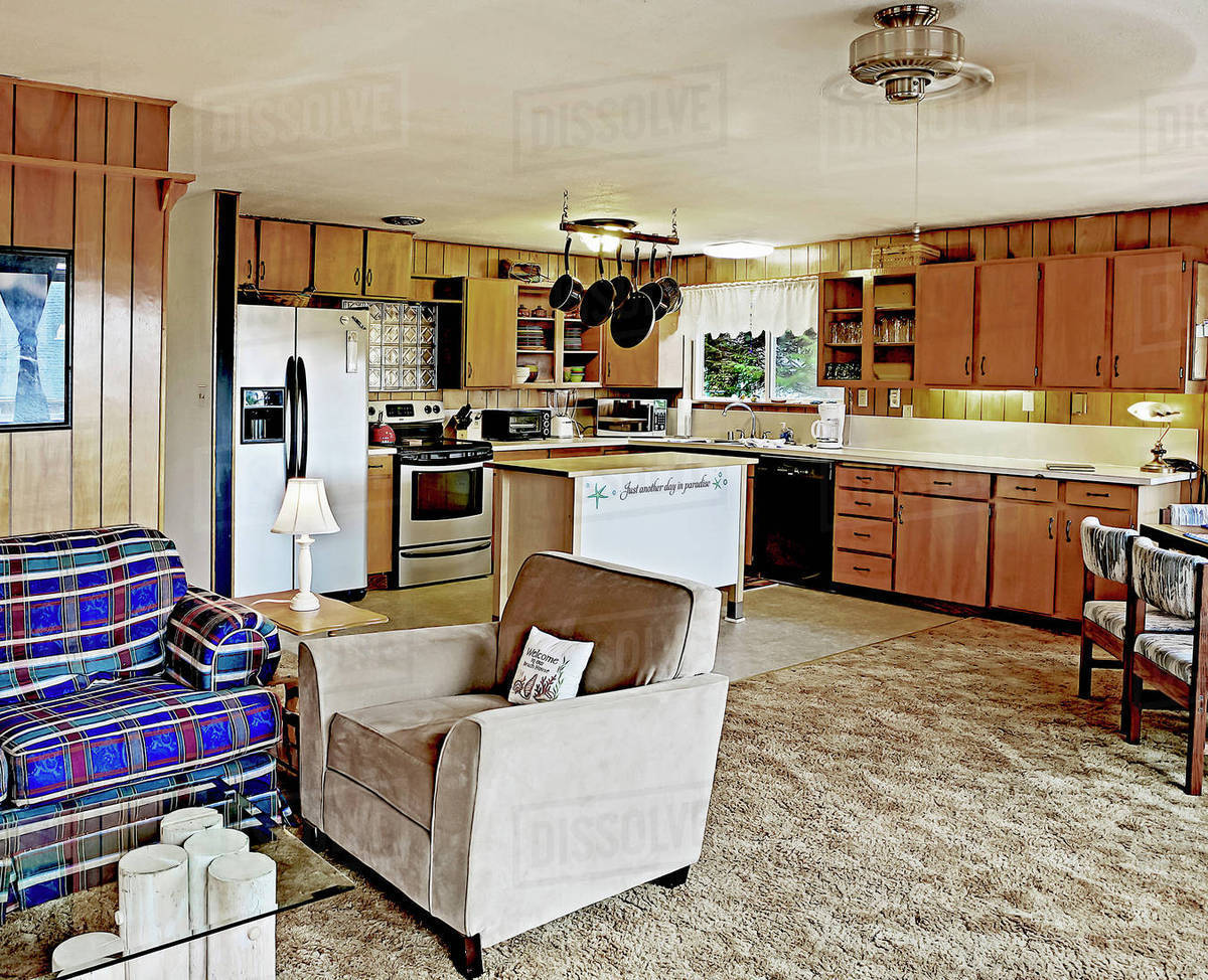 Armchair and countertops in open living room and kitchen - Royalty-free ...