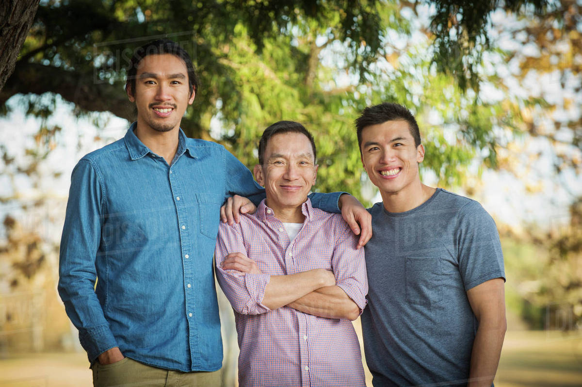 Chinese father and sons smiling outdoors - Royalty-free Stock Photo ...