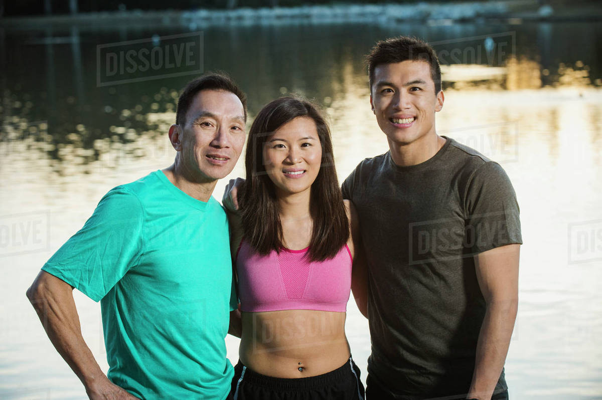 Chinese friends smiling in park - Royalty-free Stock Photo | Dissolve