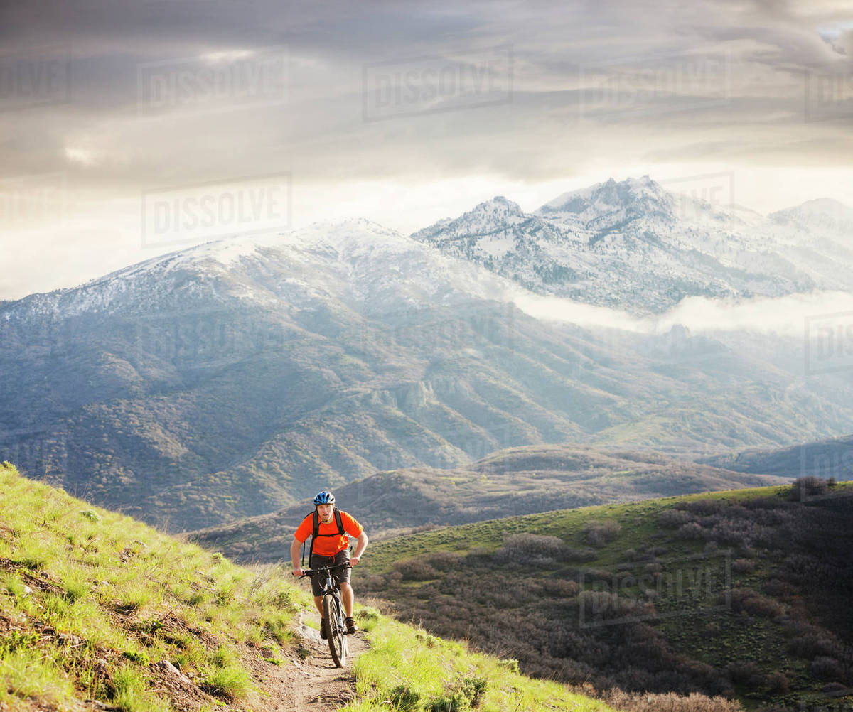Caucasian man riding mountain bike - Stock Photo - Dissolve
