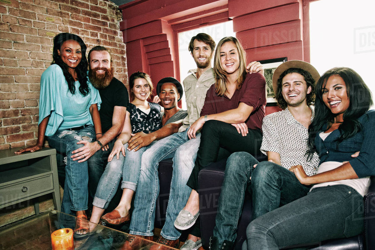 Smiling friends posing in bar - Royalty-free Stock Photo | Dissolve