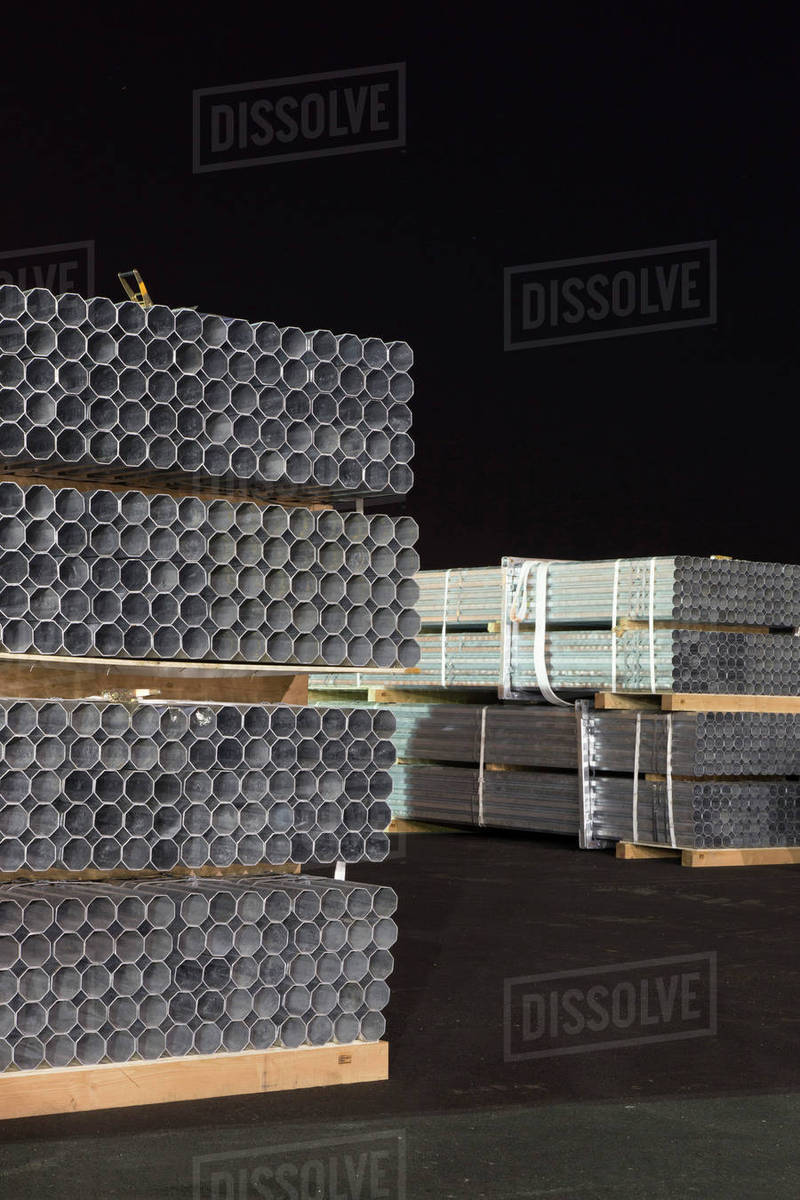 Pipes on pallets at night - Royalty-free Stock Photo | Dissolve