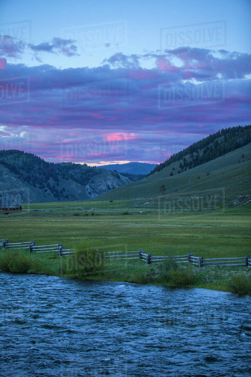 River near rolling landscape at sunset - Royalty-free Stock Photo ...