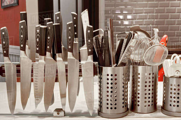 Knives on magnetic rack in commercial kitchen - Royalty-free Stock ...